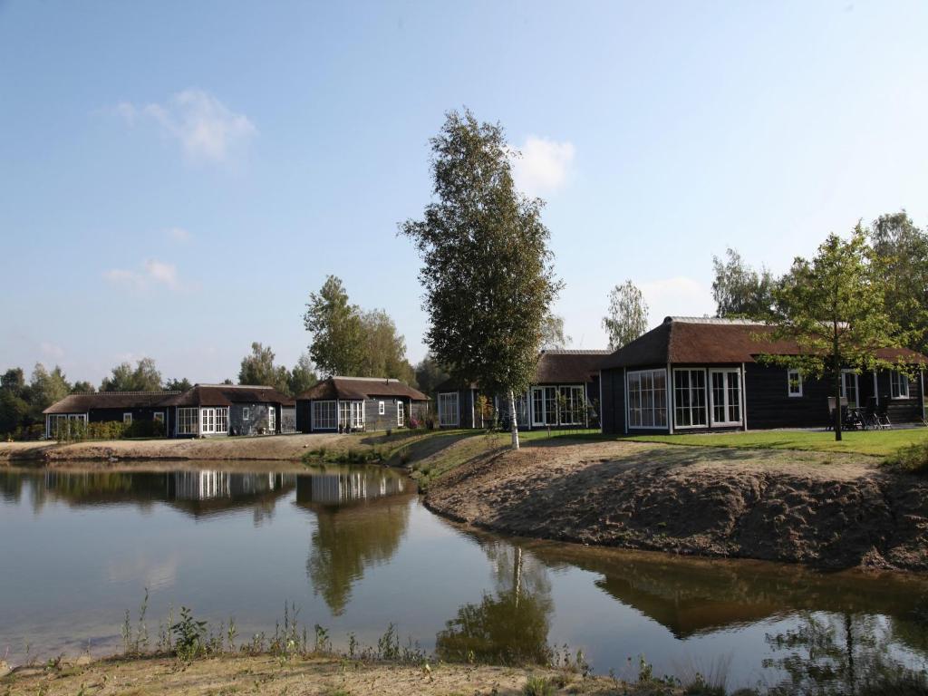 Thatched lodge with a combination microwave, at a holiday park in ...