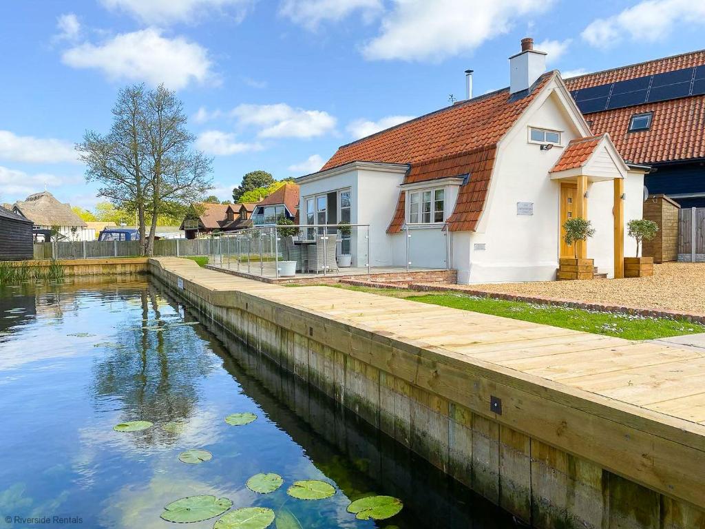 Dutch Cottage sits in its own basin off the River Bure in Horning ...