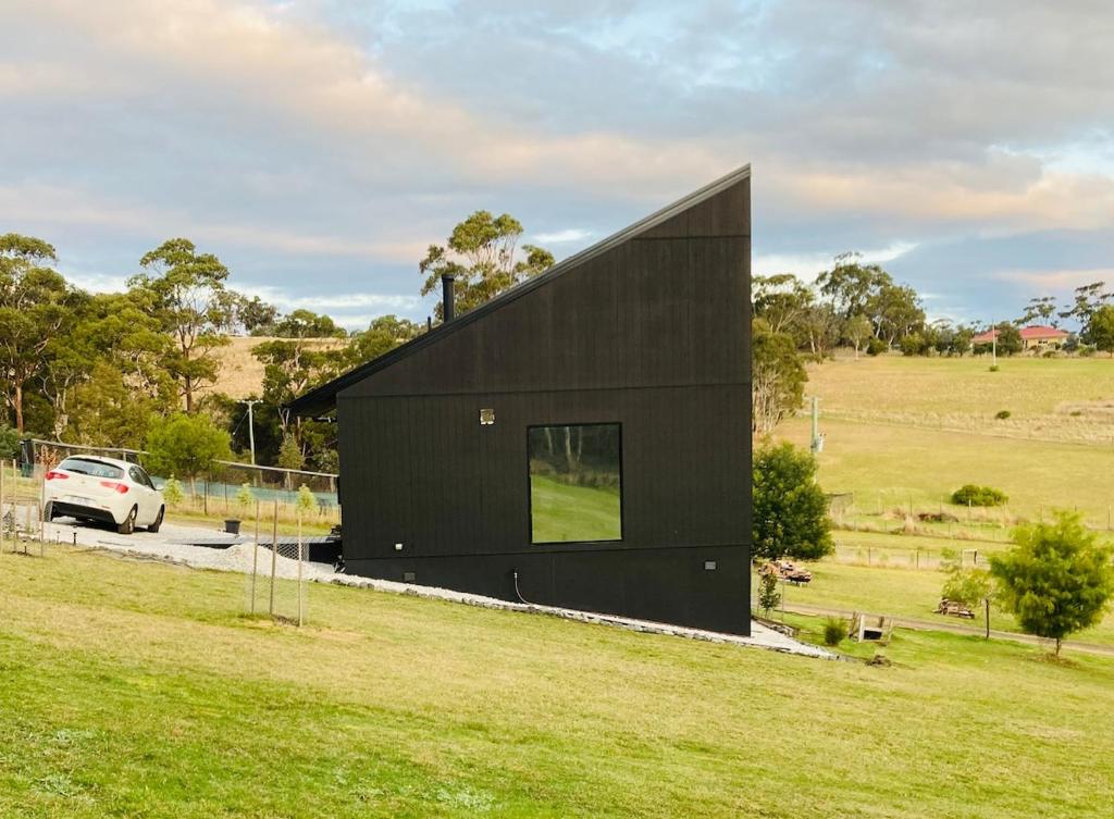 Architecturally designed cabin with outdoor bathtub and fireplace ...