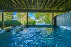 Lakefront home with private hot tub, WiFi, fun rec room, & beach area ...